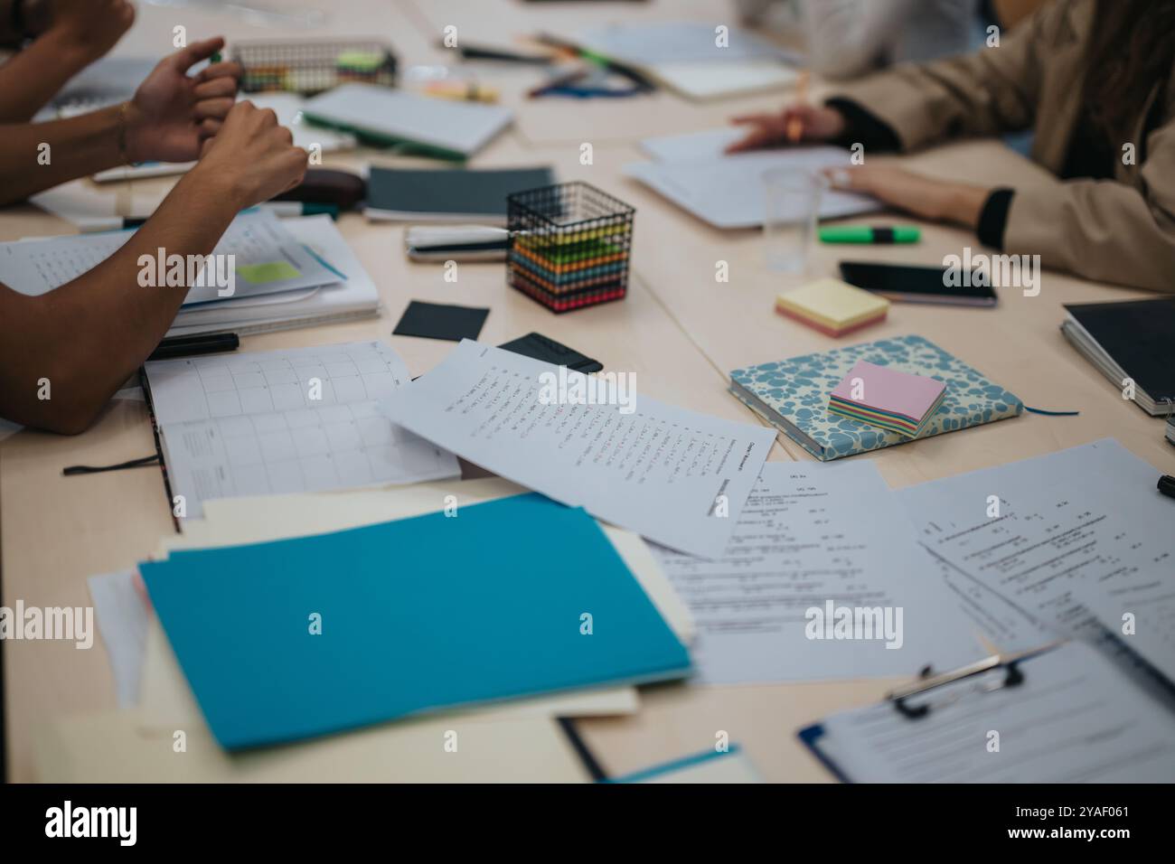 Group study session in a classroom with notes and materials Stock Photo ...