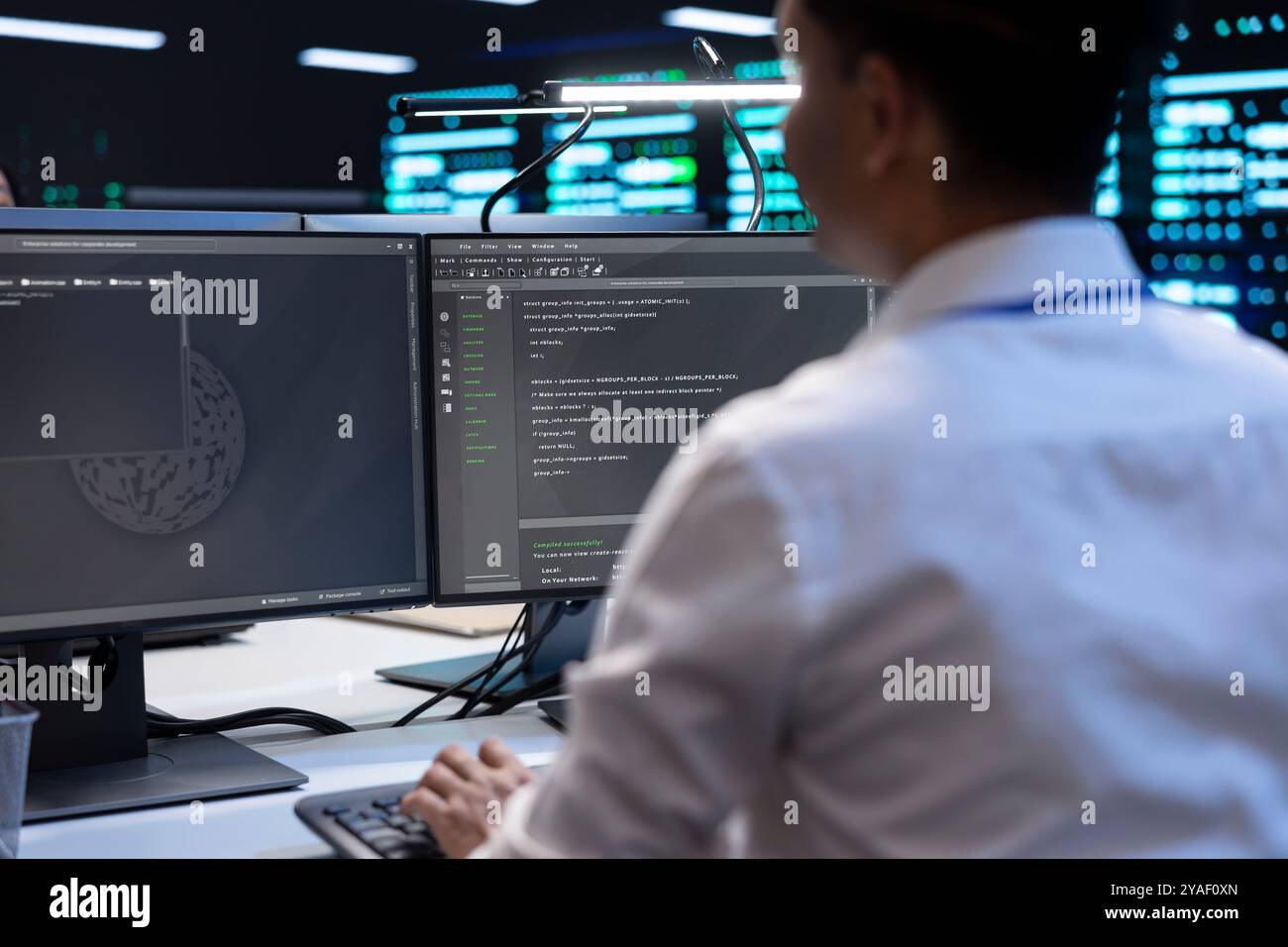 Programmer in server farm checking recovery plan, monitoring data center energy consumption ...