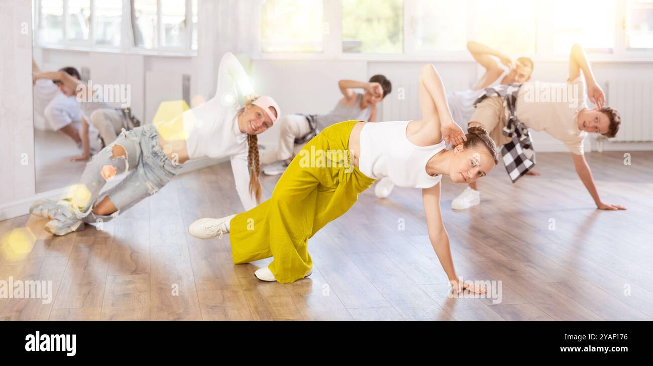 Teenage girl dancing breakdancing in group Stock Photo - Alamy