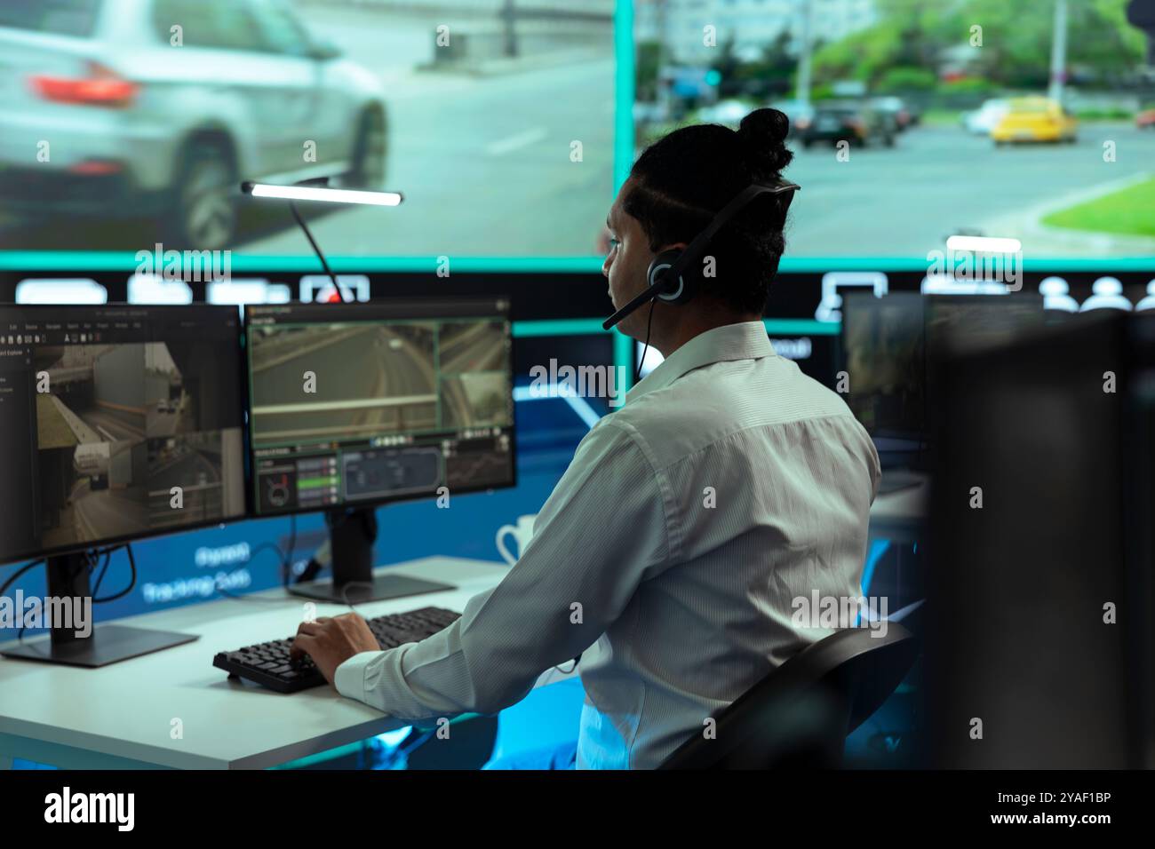 Indian expert looking at surveillance footage in a monitoring room ...