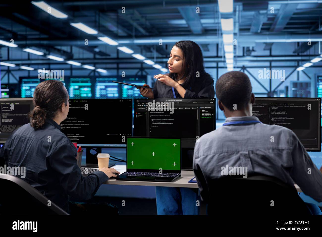 Multiethnic team in server room checking recovery plan and monitoring energy consumption using ...