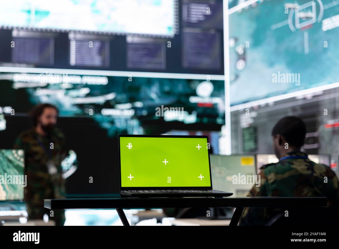 Green screen running on laptop in military base of operations, team of ...