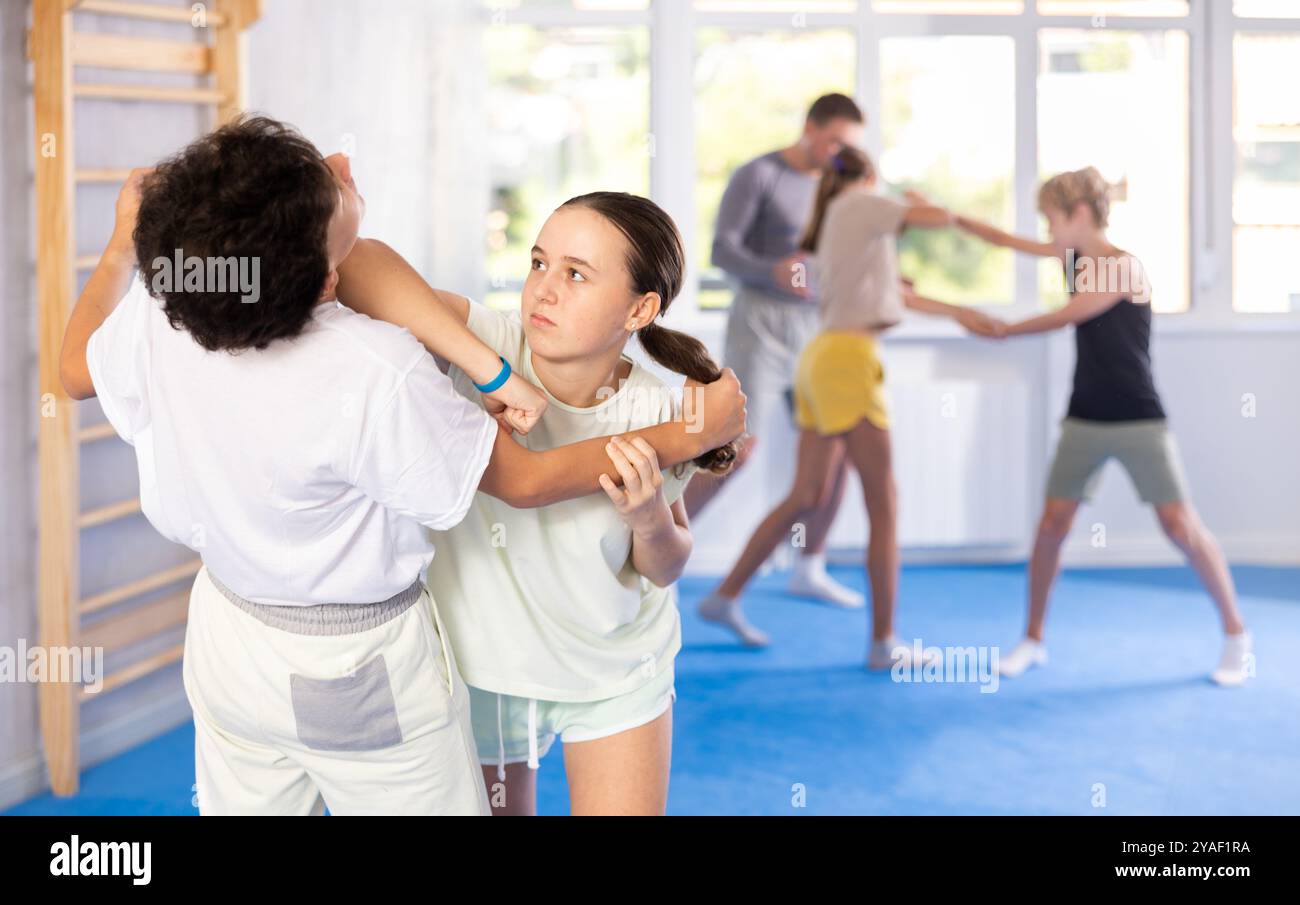Boy and girl practicing self-defense techniques Stock Photo - Alamy