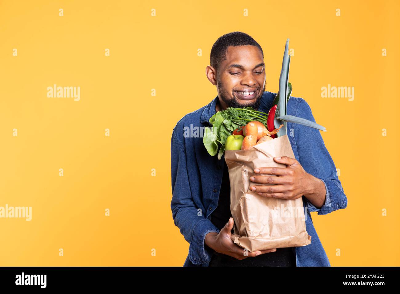 Happy african american guy feels excited about healthy eating and bio ...