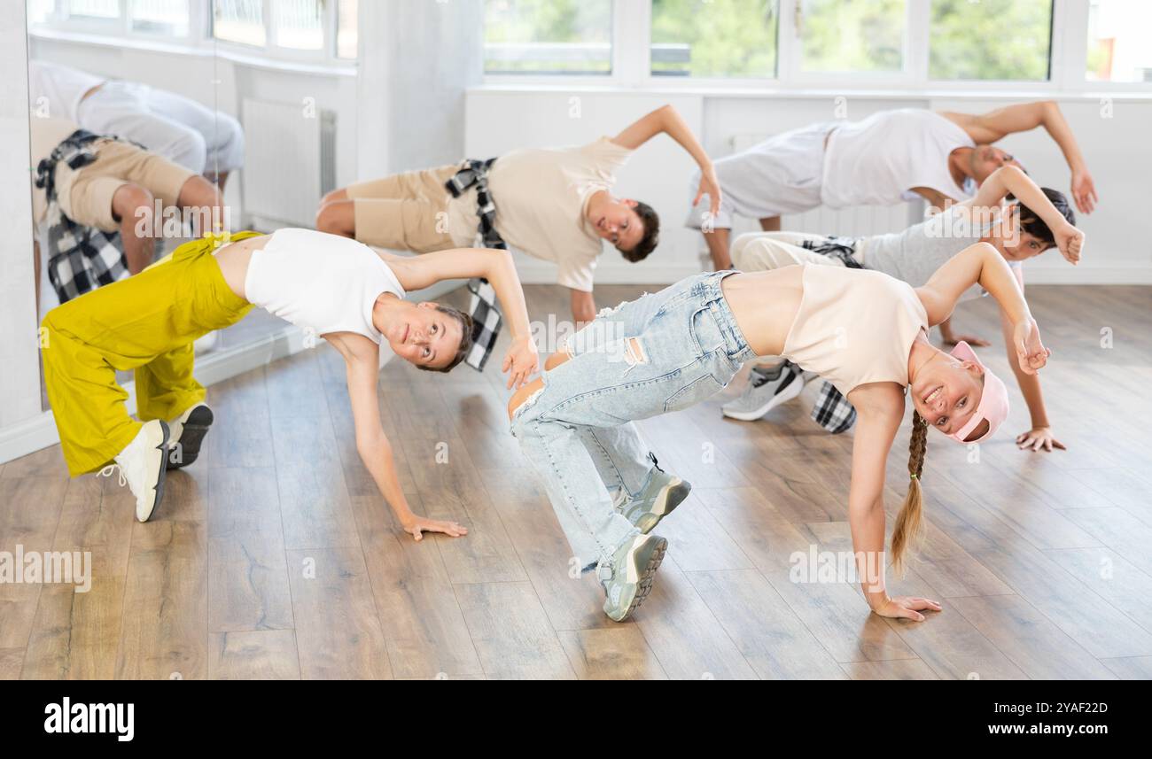 Girl in baseball cap with two hair pigtails with group of teenage ...