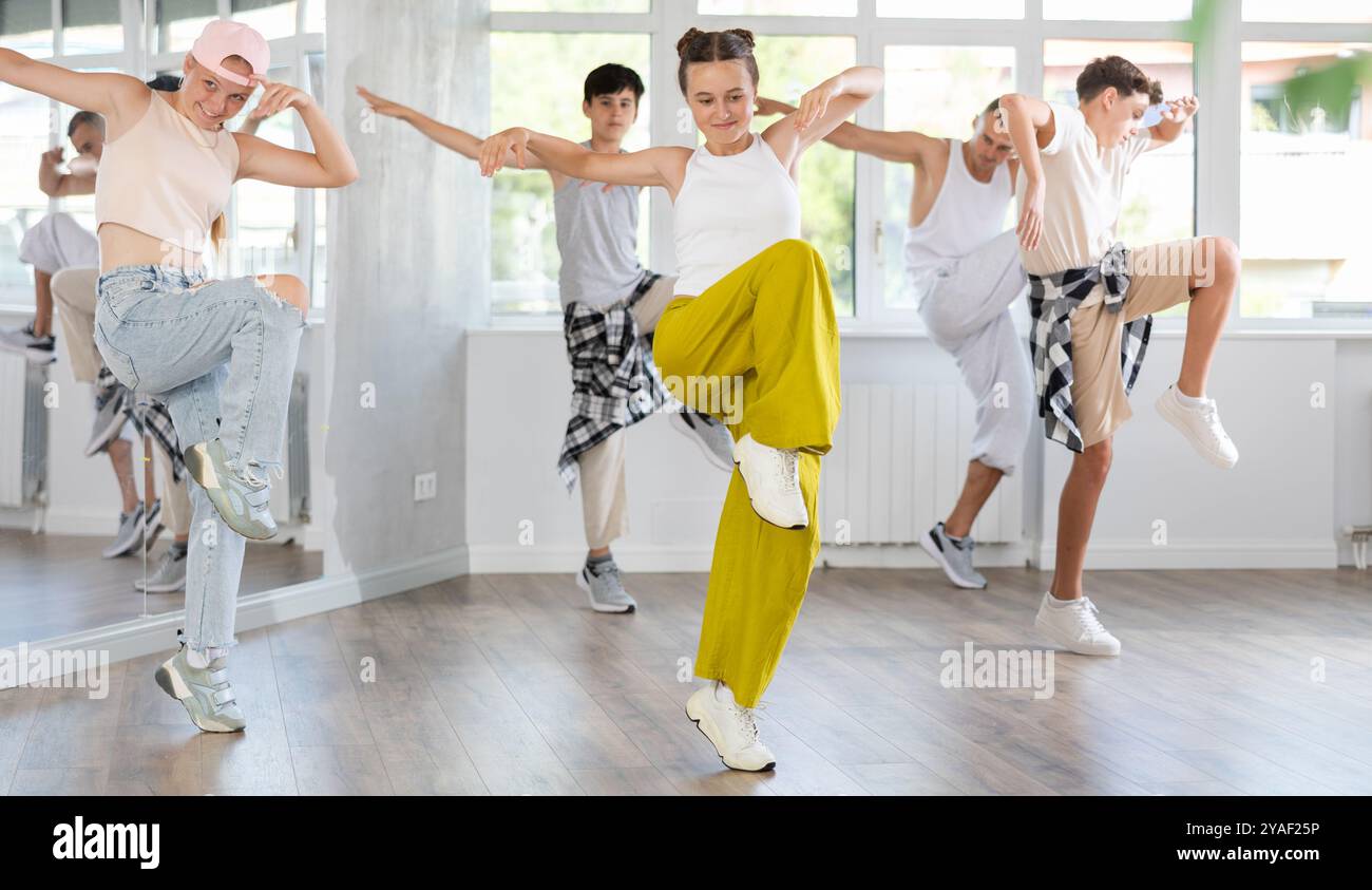 Teenage girl practicing hip hop reject step in training hall Stock ...