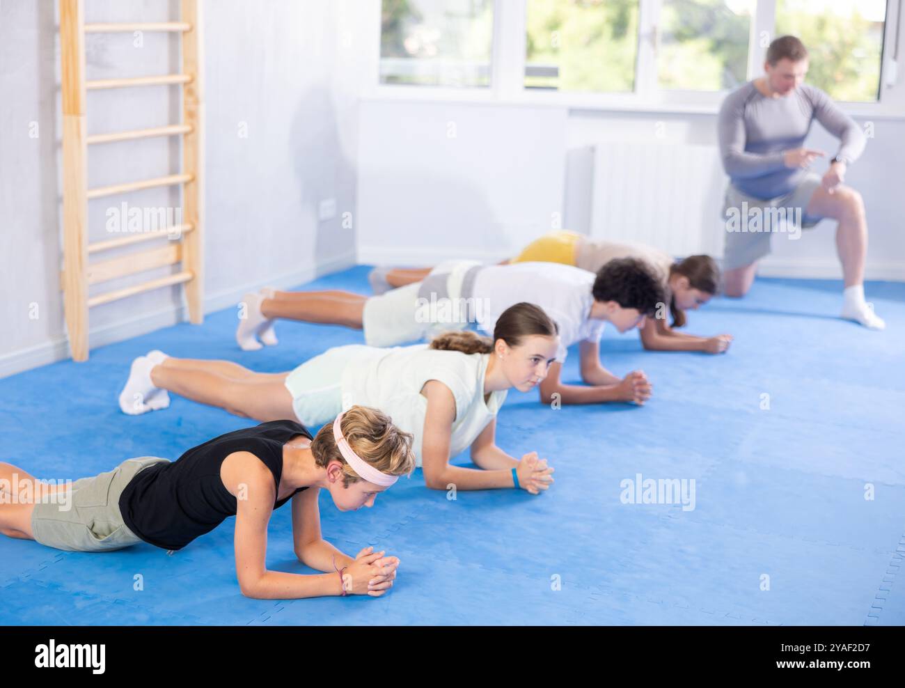 Child pupils performs plank exercises Stock Photo - Alamy