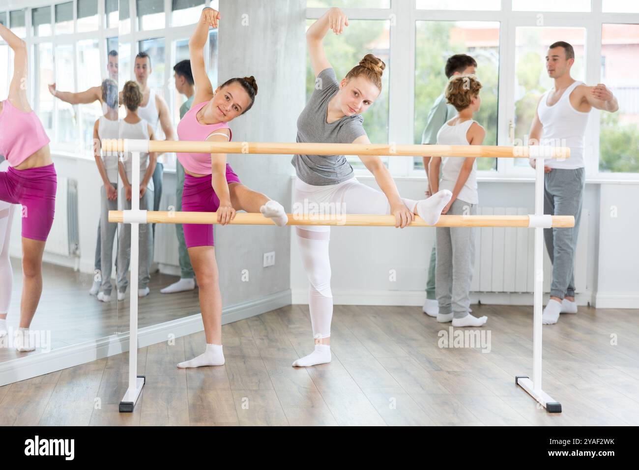 Ballet pose grand batman - girls and boys at a choreography lesson are ...