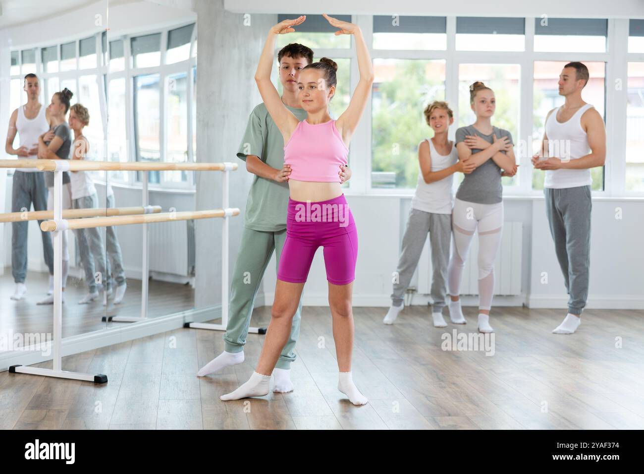 Ballet studio - teenagers girls and boys learn ballet movements in ...