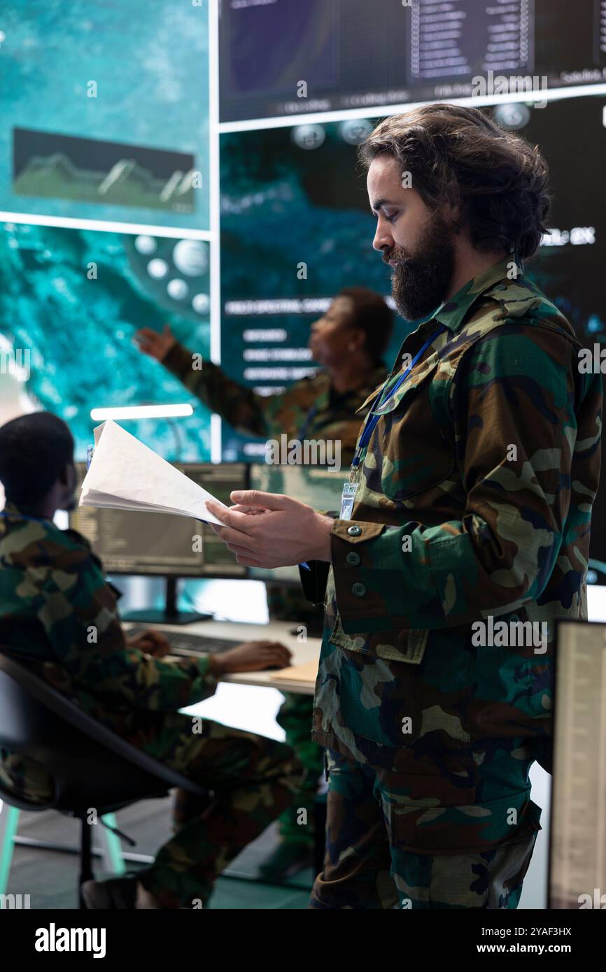 Special operations engineer reviewing operation case file before ...
