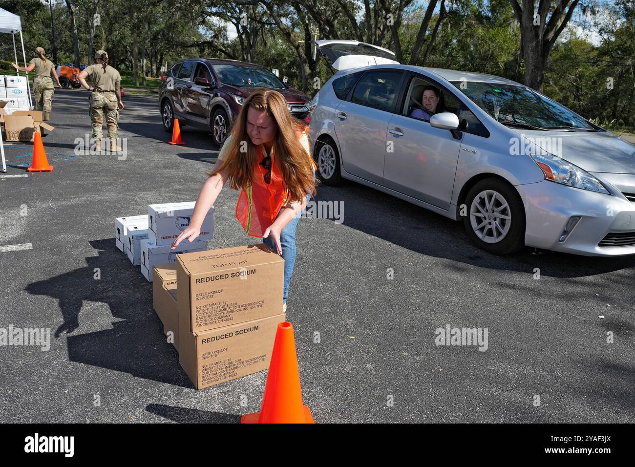 Hillsborough County employee Priscille Traugh helps load supplies into ...
