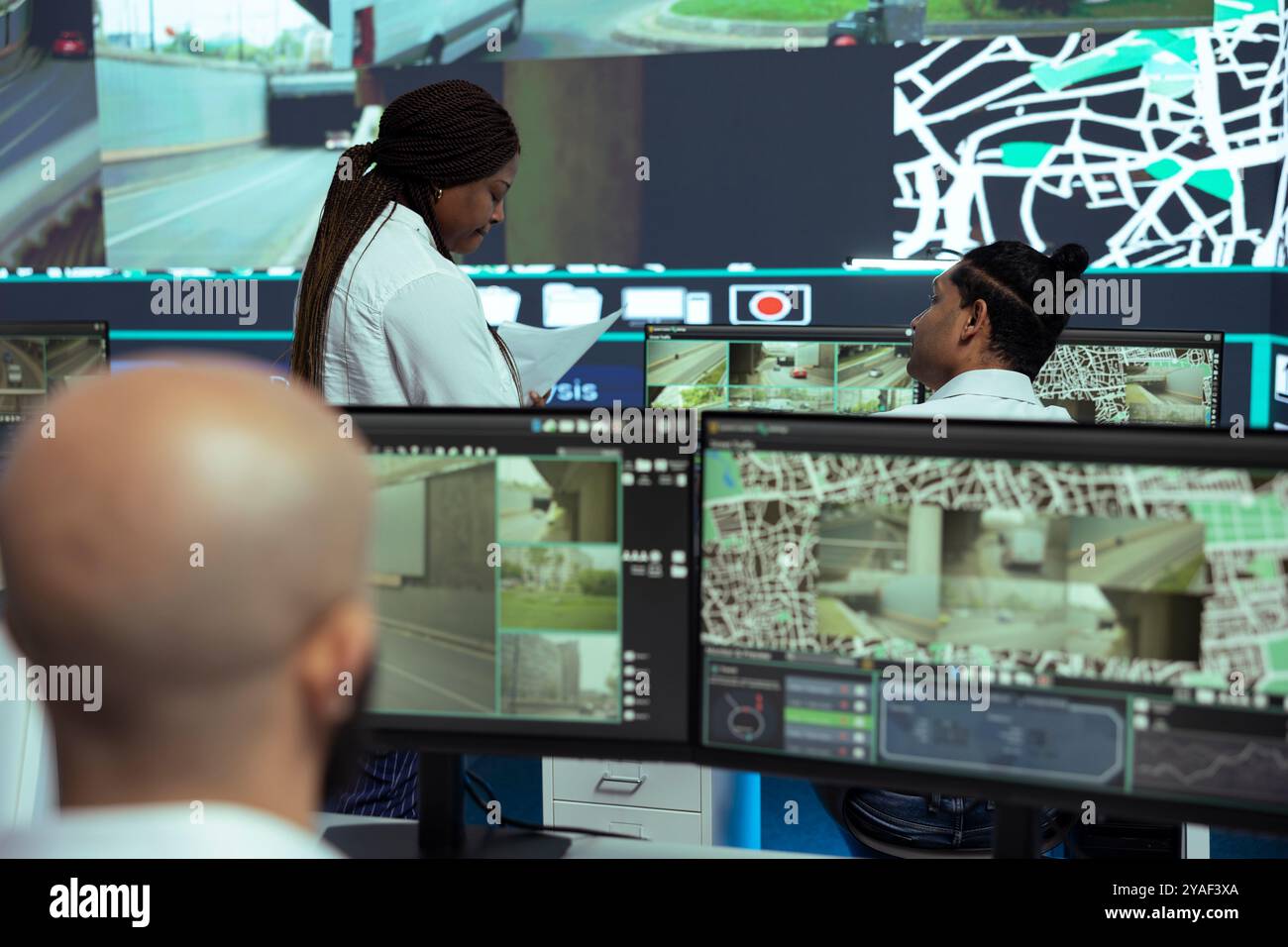 Indian employee receiving instructions from african american manager on ...