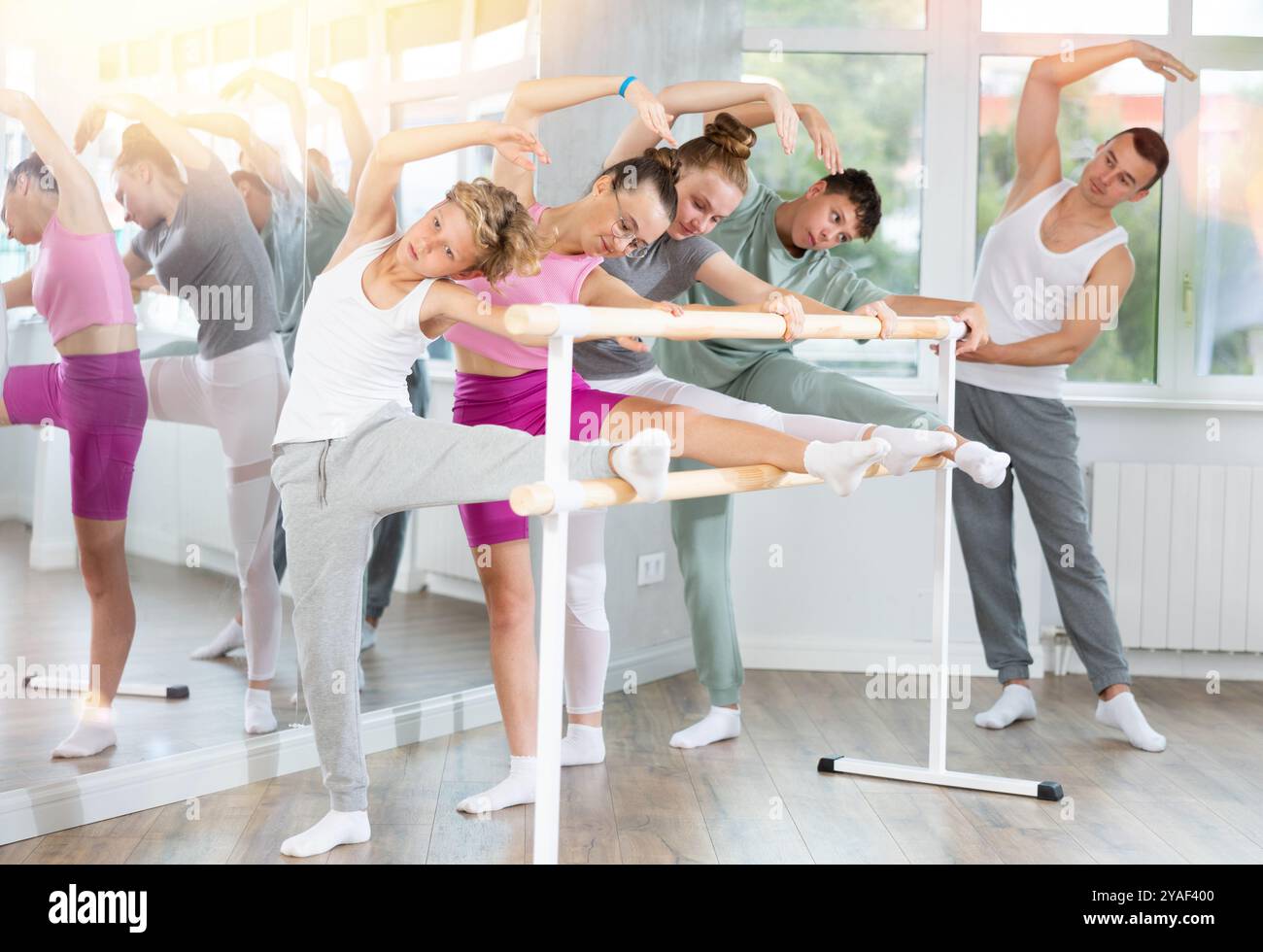 Ballet pose grand batman - girls and boys at a choreography lesson are ...