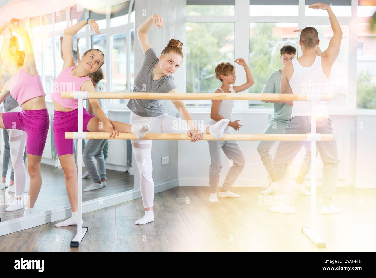 Ballet pose grand batman - girls and boys at a choreography lesson are ...