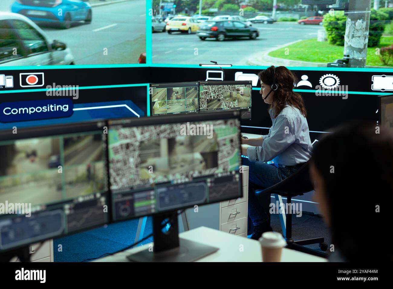 Control center operator monitoring surveillance footage to find ...