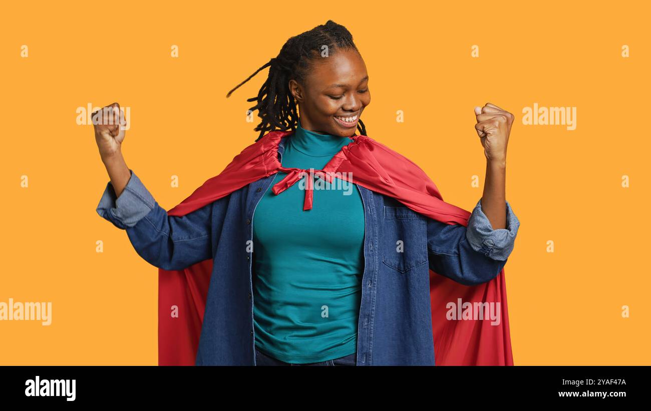 Happy superhero flexing muscles to prove force, listening music ...