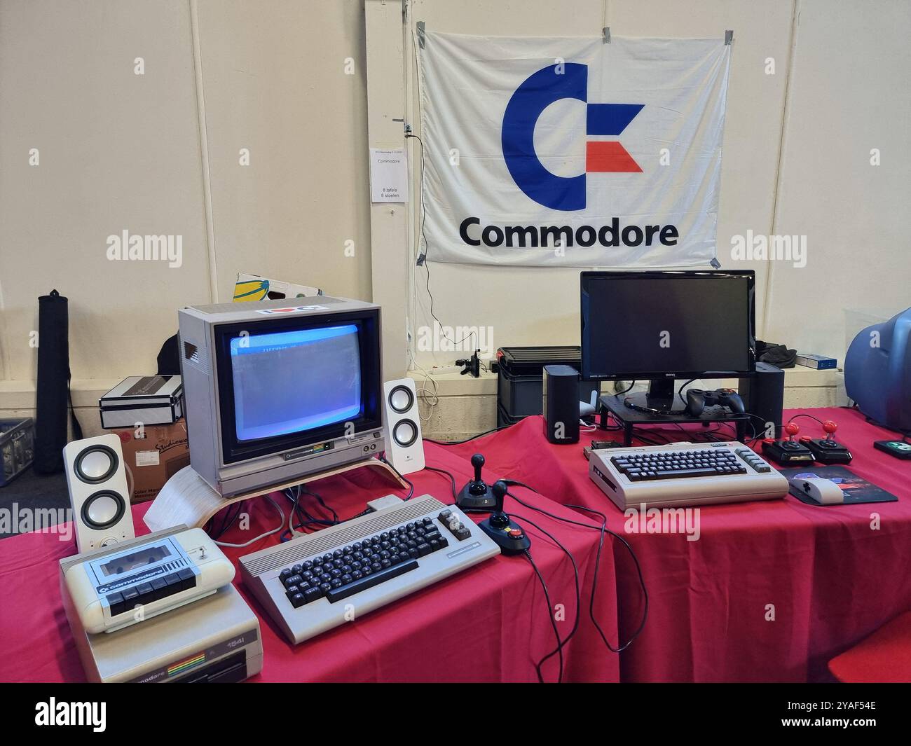 Old, historic, vintage Commodore computers with monitors & cassette recorder on display on a red ...