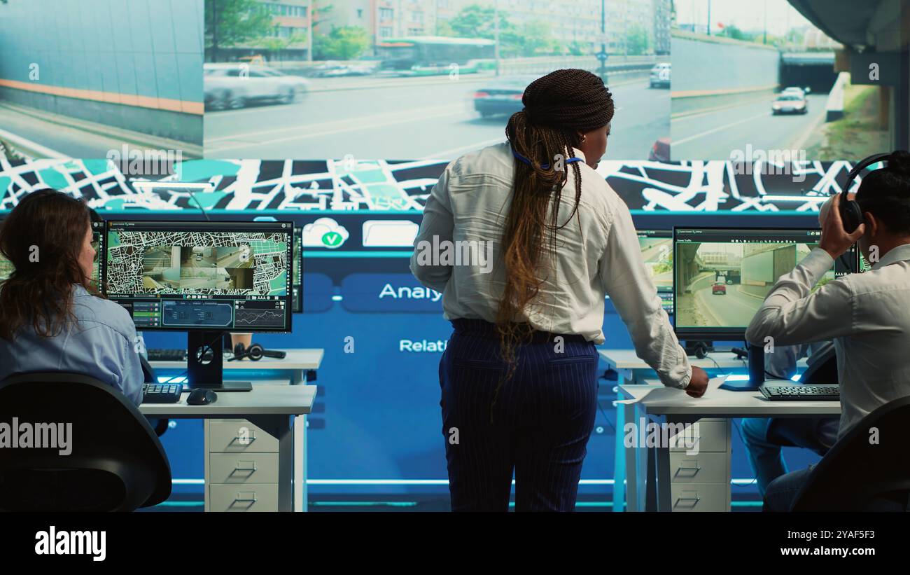 Team leader gives order tracking details to her employees in control ...