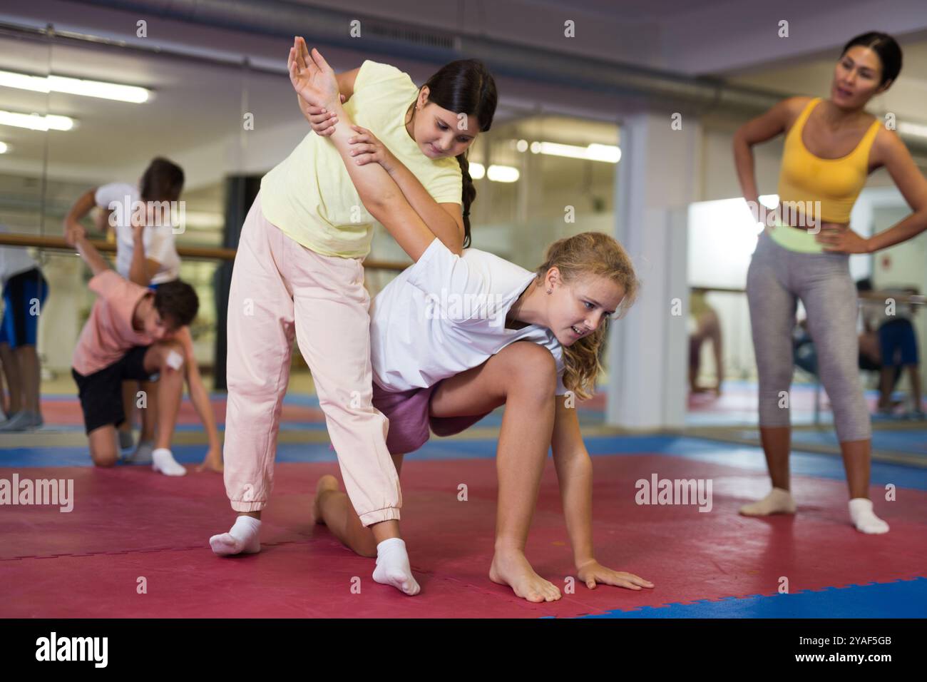 Girls and boys try to make painful grip on the attacker arm during ...