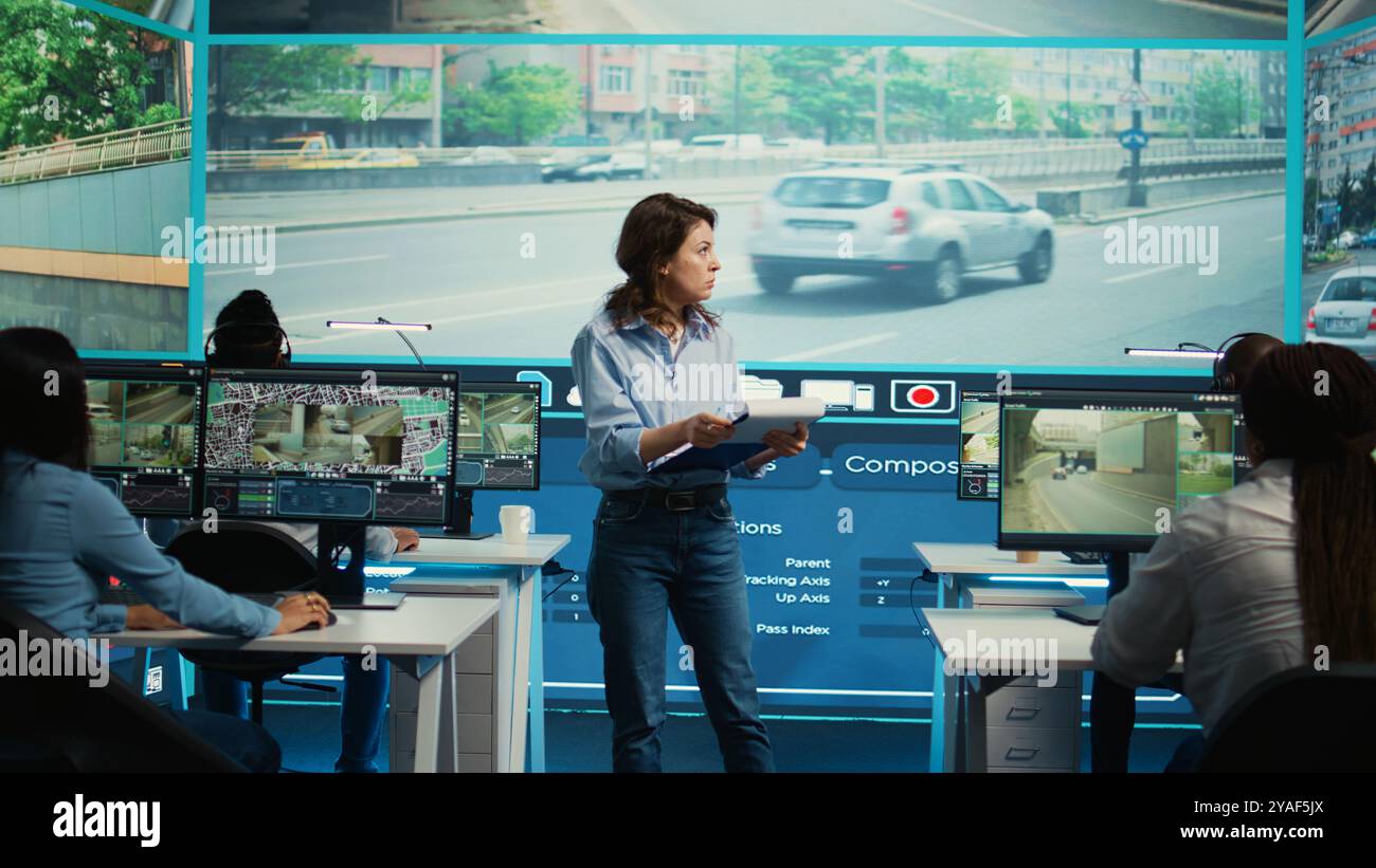 Manager overseeing employees in monitoring traffic activity, operating ...