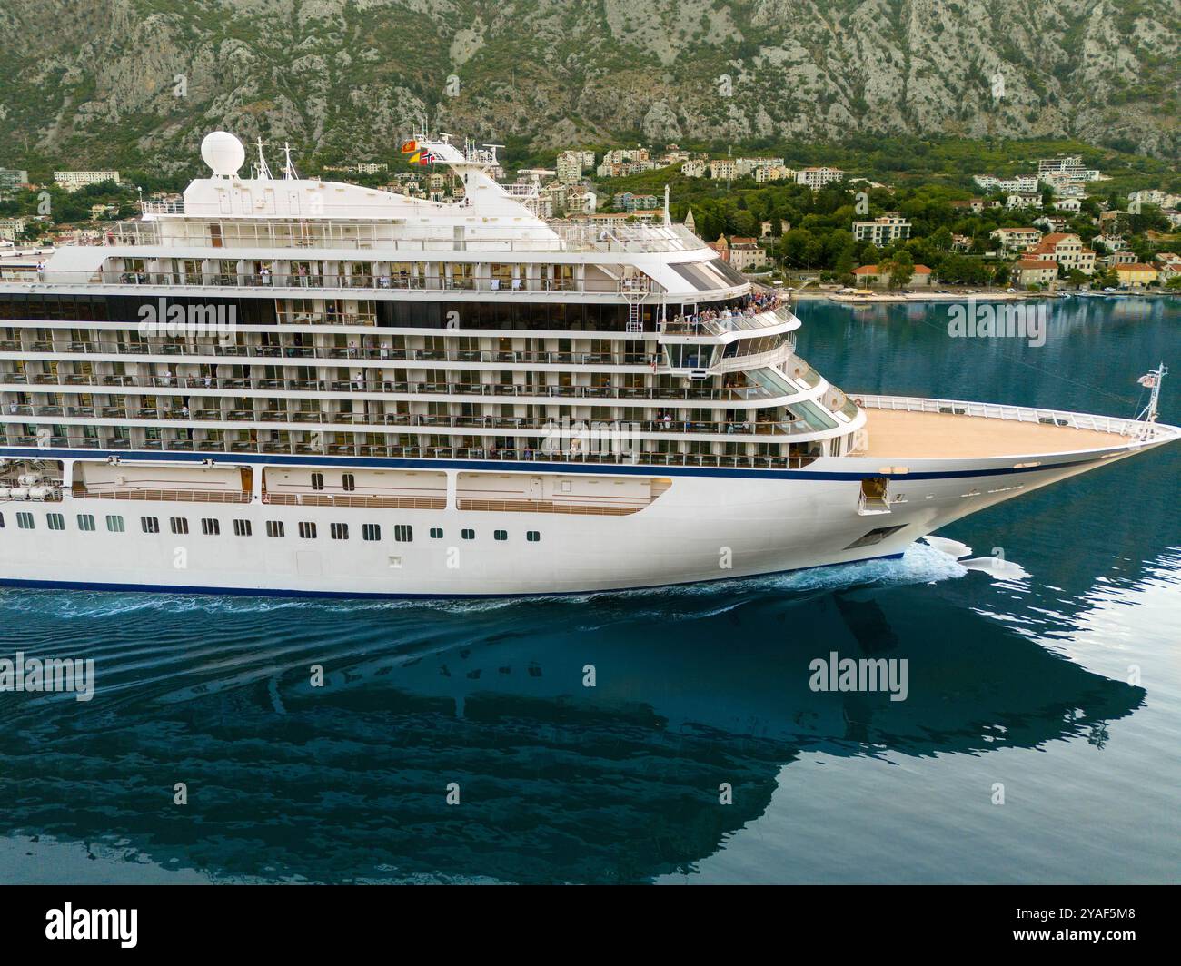 Cruise ship sailing in the bay to the berth, side view of the decks and ...