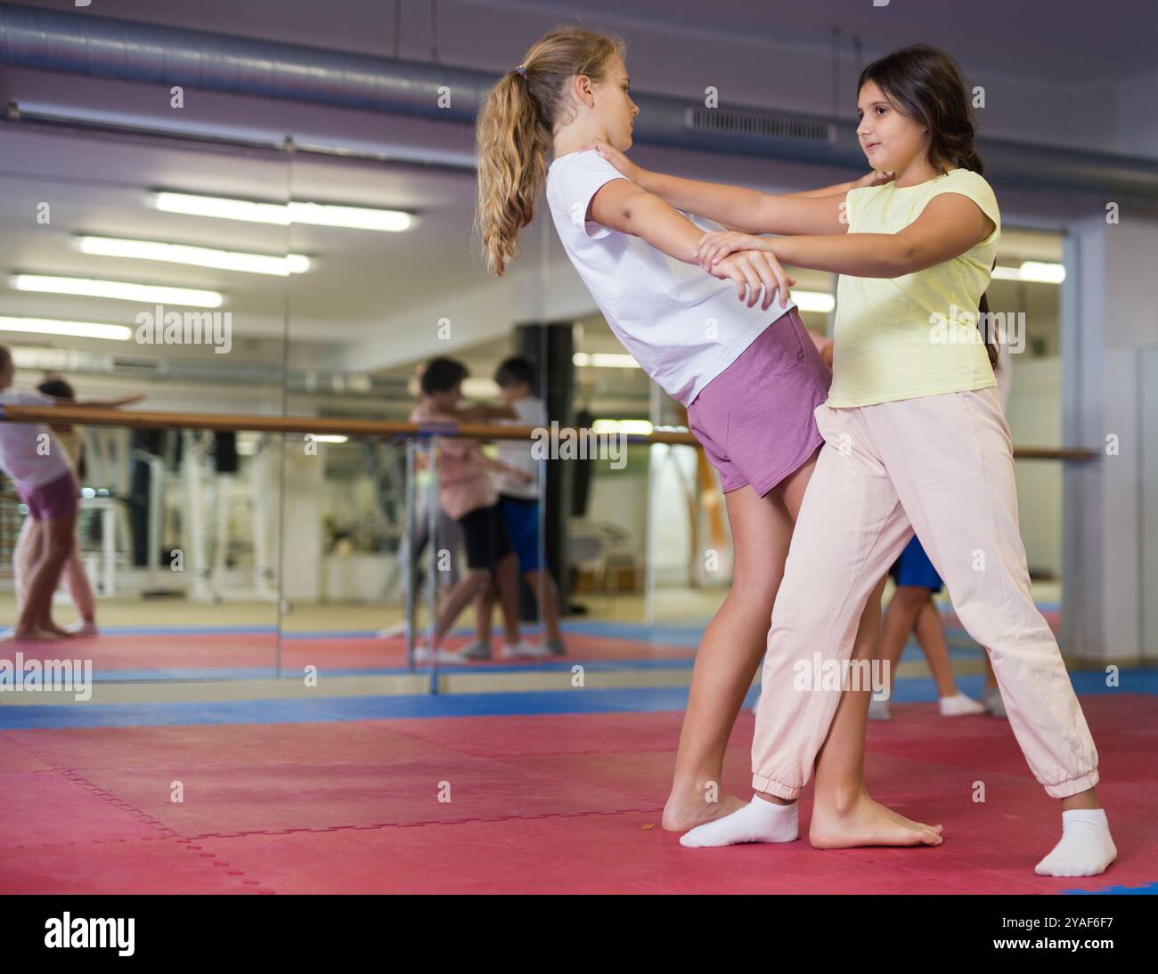 Two school girls practicing self-defense moves Stock Photo - Alamy