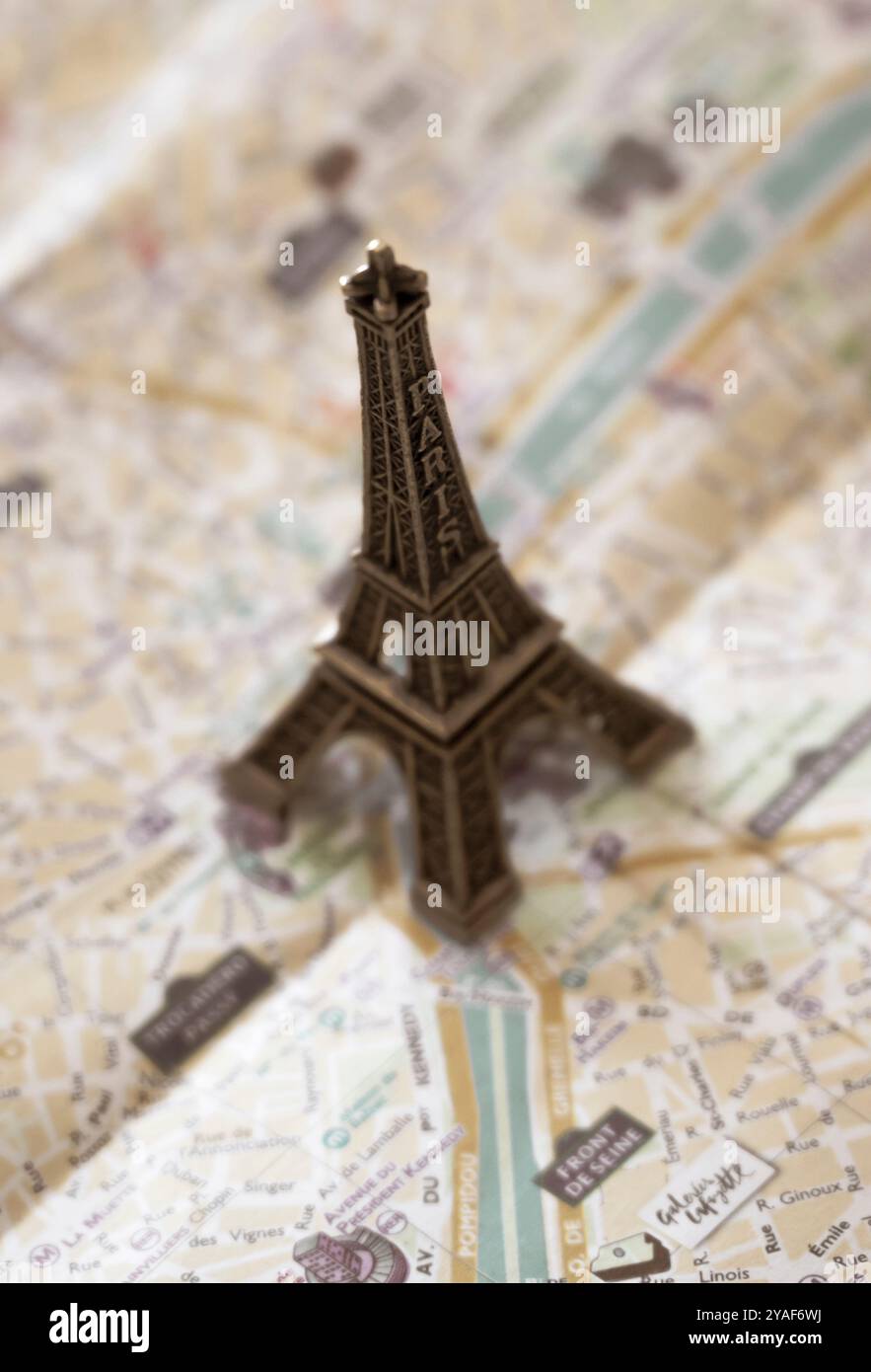 Minitature Eiffel Tower sits on map of Paris, France Stock Photo - Alamy