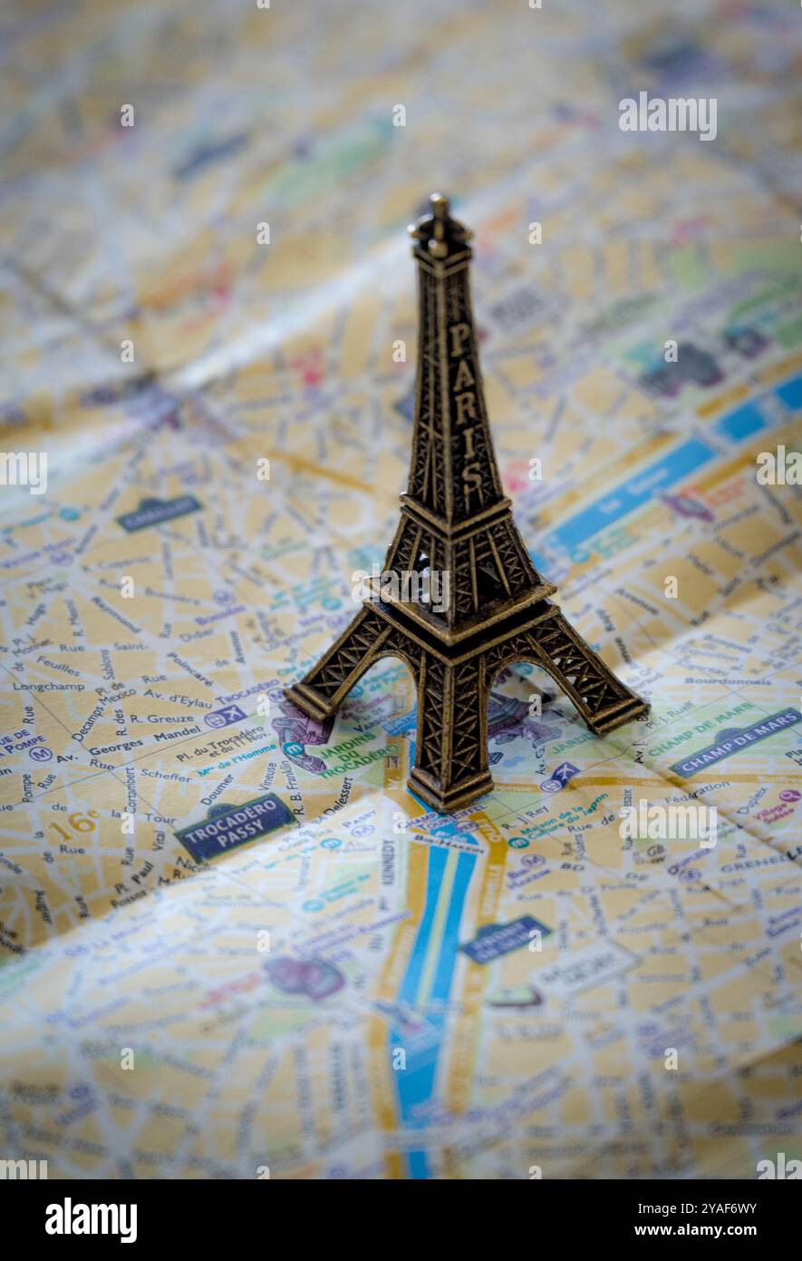 A miniature Eiffel Tower sits on map of Paris, France Stock Photo - Alamy