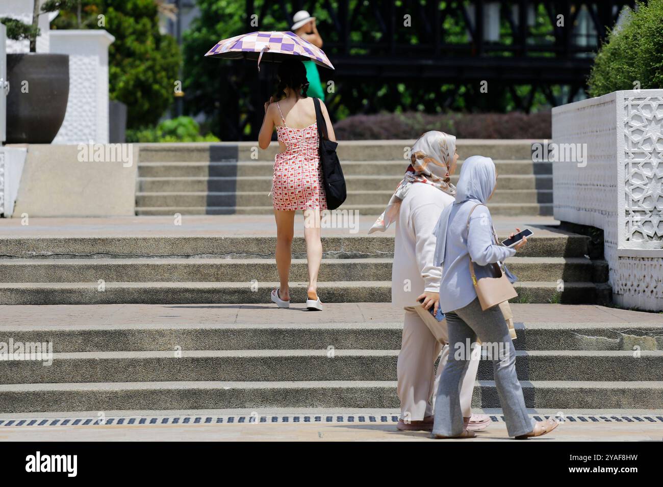 Kuala Lumpur, Malaysia - August 20, 2023: Muslim women chat as they ...