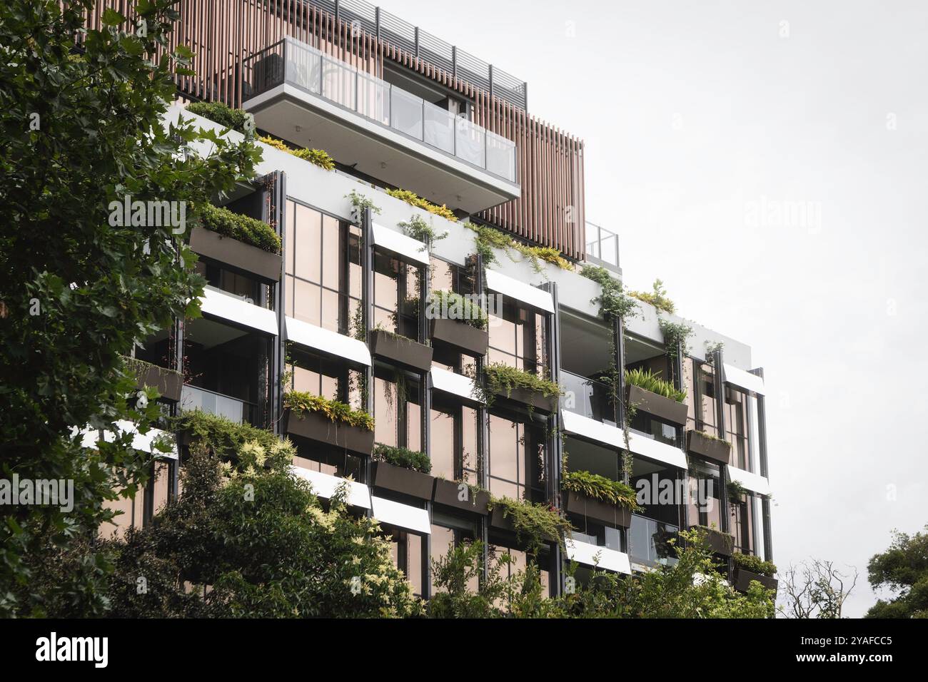 Clean green energy urban building covered in plants and fauna ...