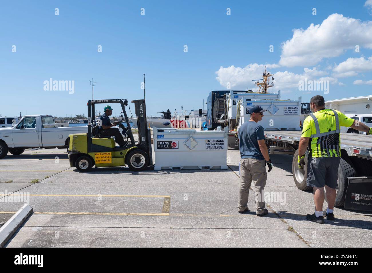 U.S. Coast Guard members offload fuel containers at Coast Guard Sector ...