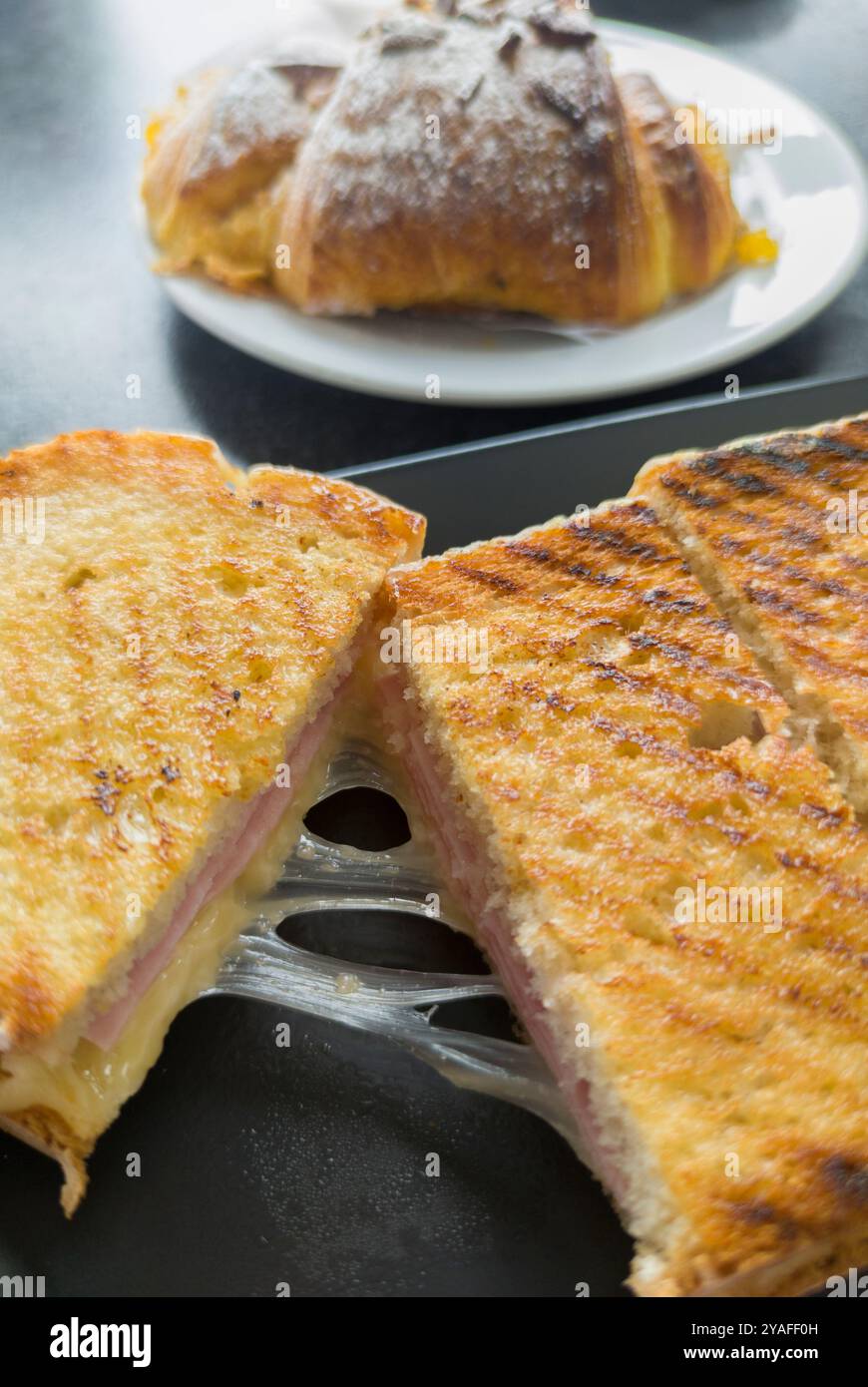 Toasted ham and cheese sandwich and sweet bun on the bottom. Salty and ...