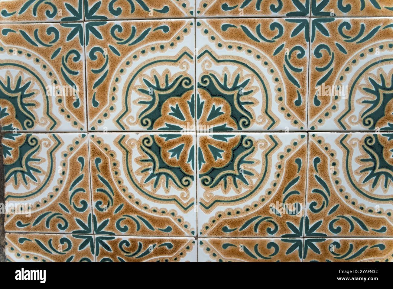 Detailed traditional tile pattern in shades of green and brown ...