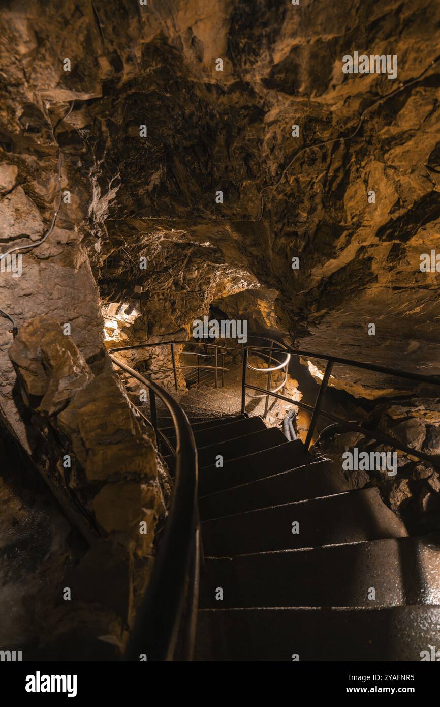 A spiral staircase in a dark cave leading into the depths, St. Beatus ...