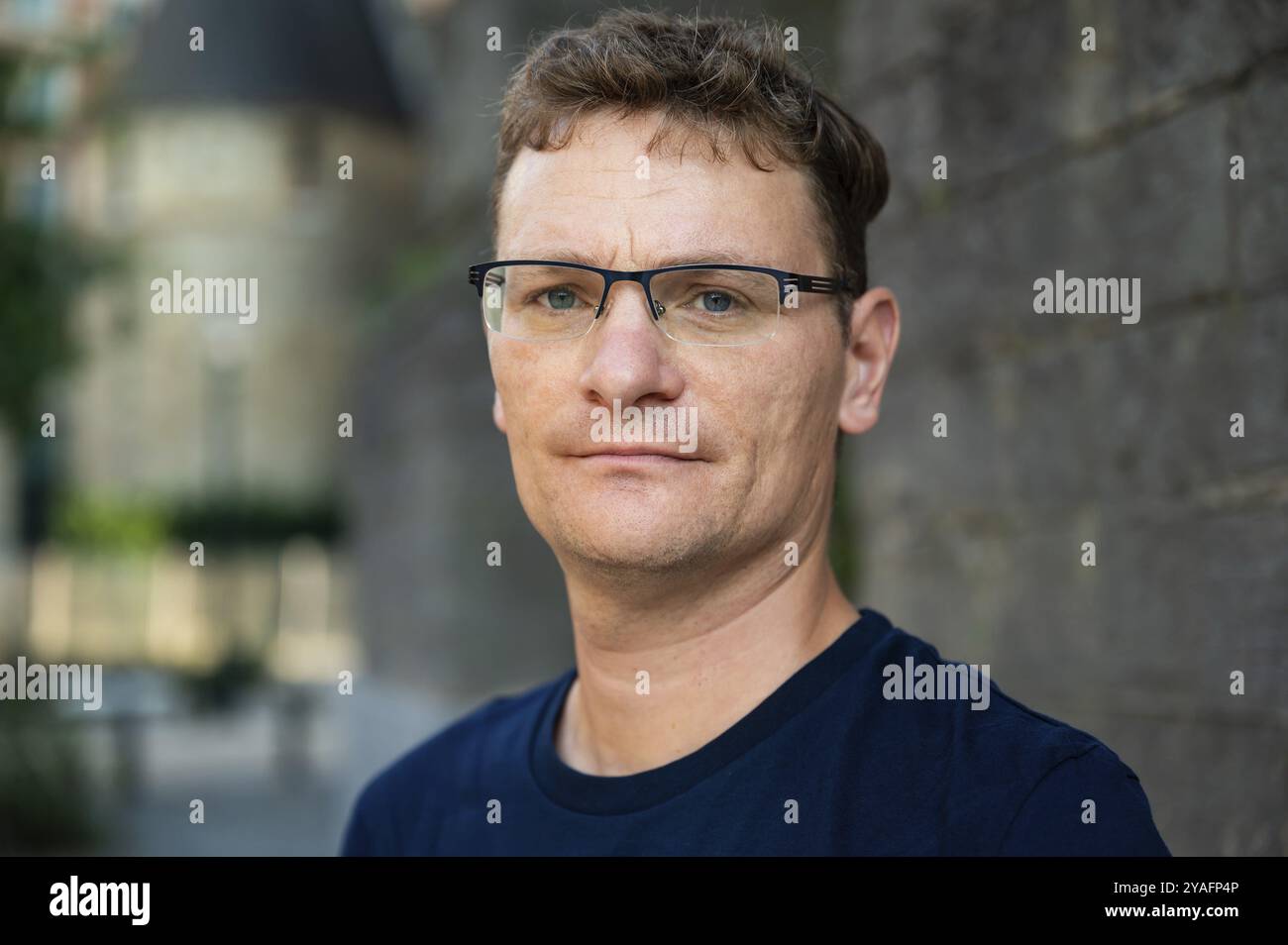 Outdoor portrait of a serious 44 yo white man with eyeglasses, Brussels ...