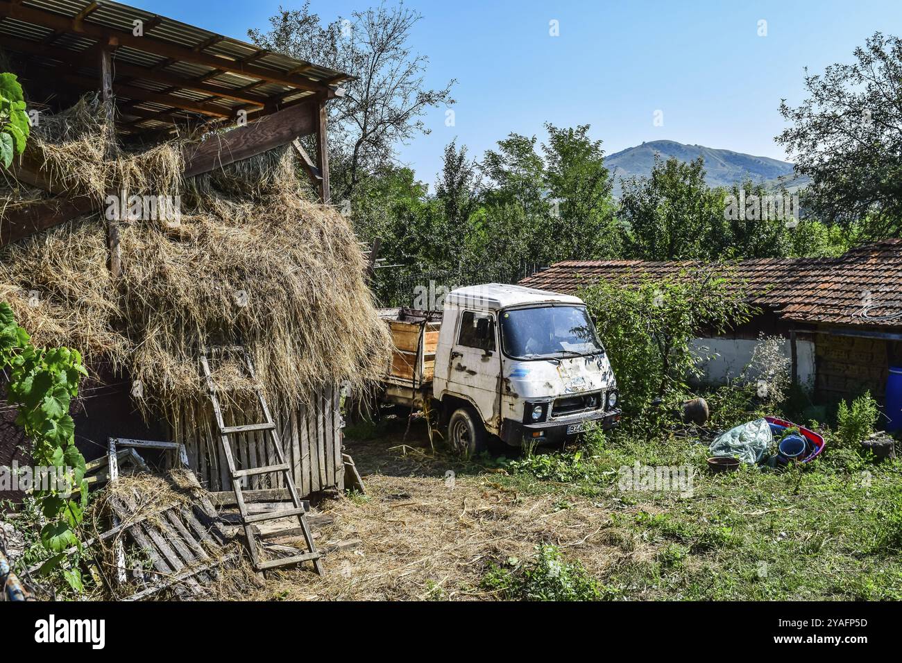 Shed, hay, old vehicle and stalls in Romania Stock Photo - Alamy