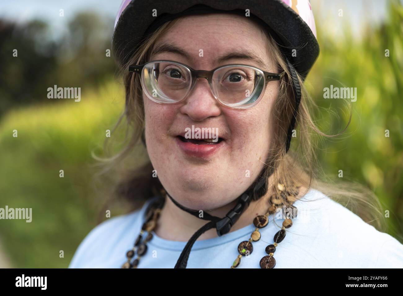 Outdoor portrait of a 39 year old cheerful woman with down syndrome ...