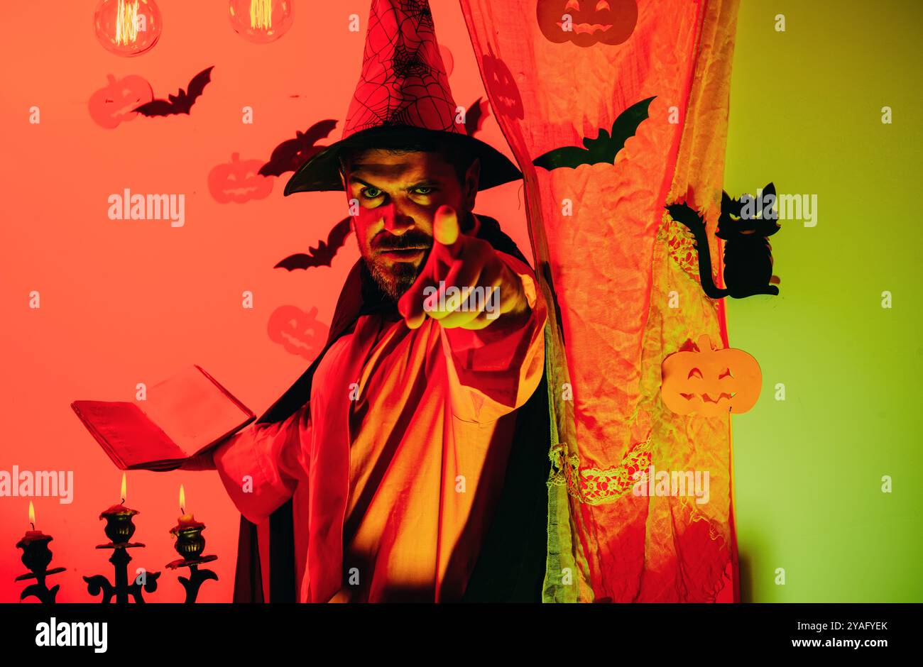 Evil witcher with red hair and a beard in a black cloak reading a book ...