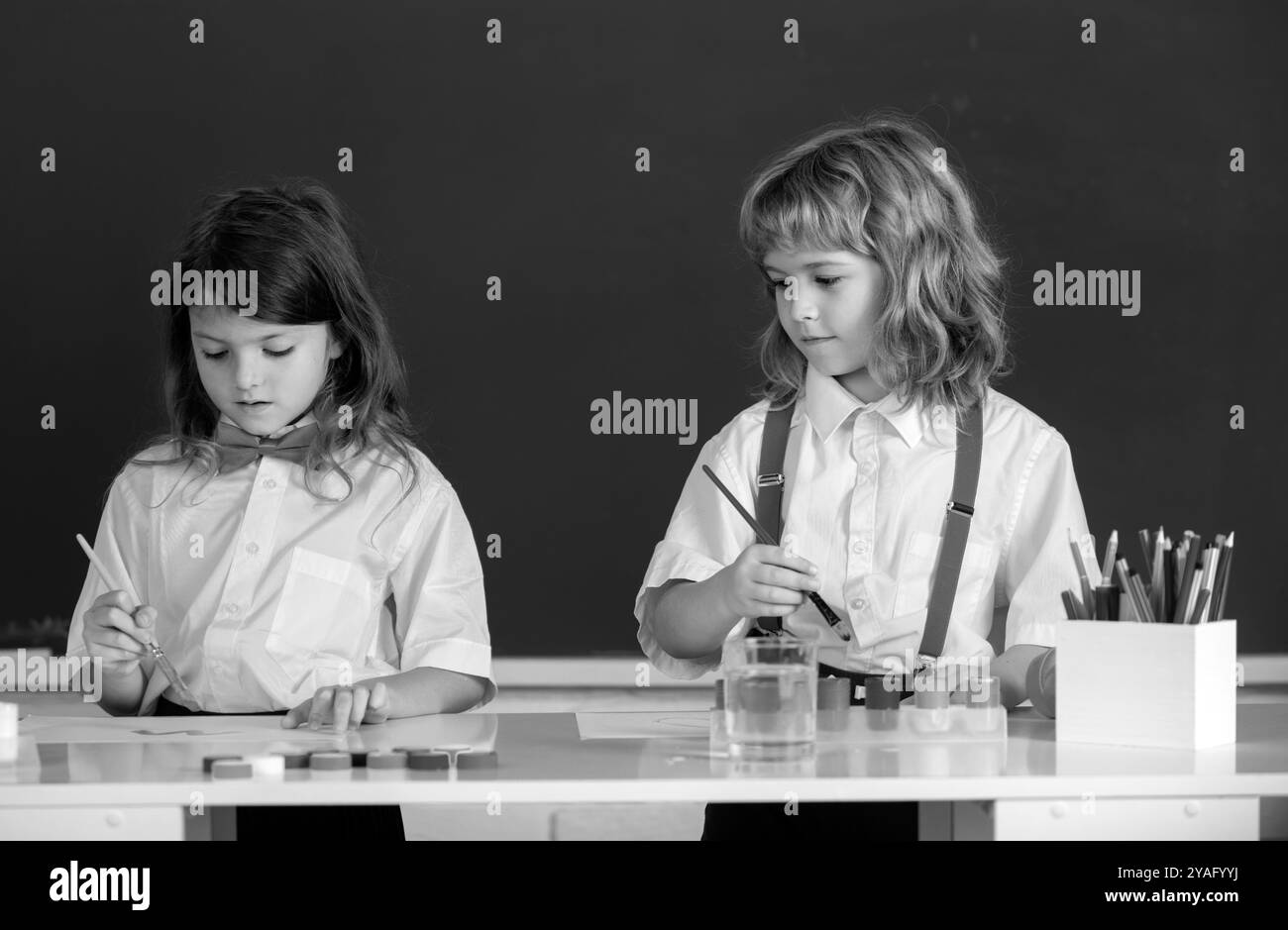 Cute school friends kids drawing and painting at school. Friendly boy ...