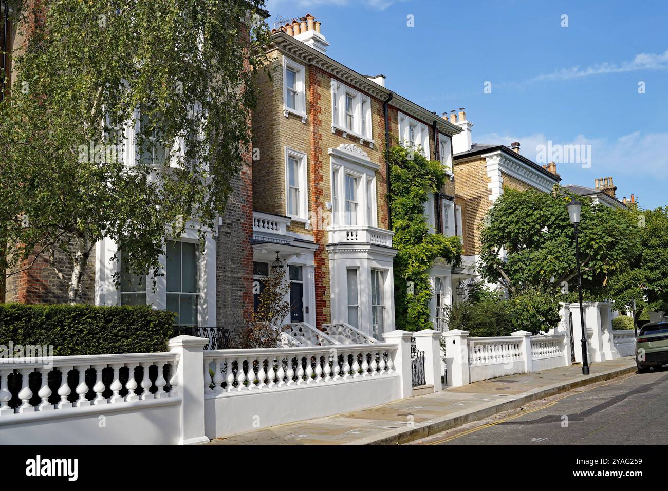 Elegant street of colorful old brick townhouses and apartment buildings ...