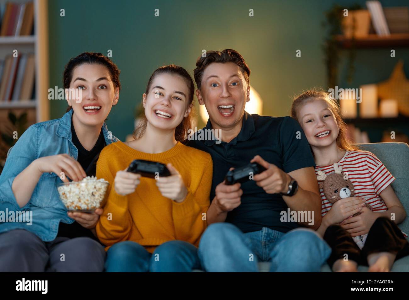 Happy family together. Mother, father and their children girls playing ...