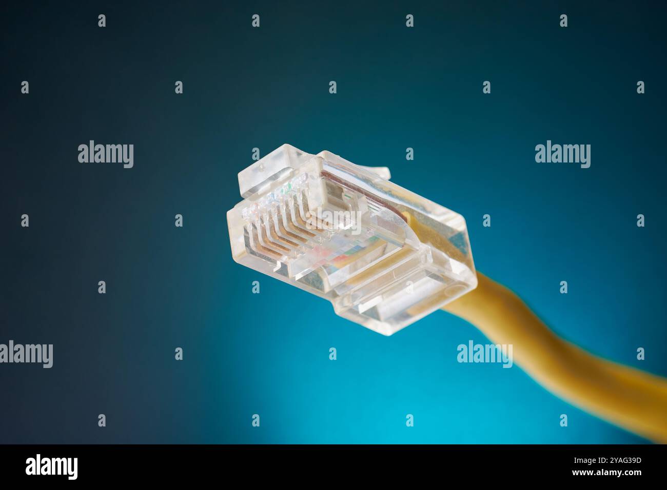 close-up of rj-45 ethernet networking jack connector isolated blue background, used to connect ...