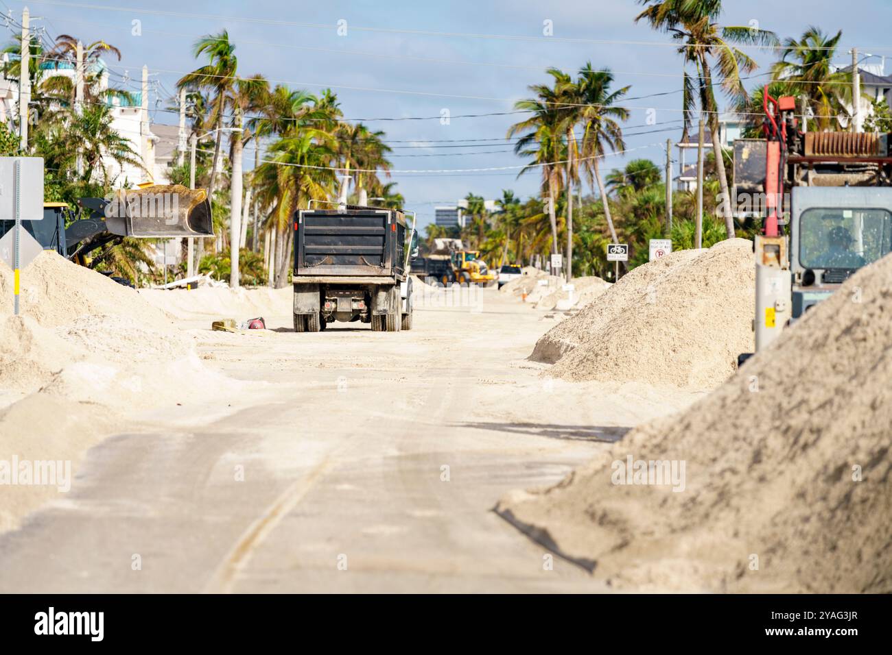 Trucks removing sand from Hurricane Milton storm surge Stock Photo - Alamy