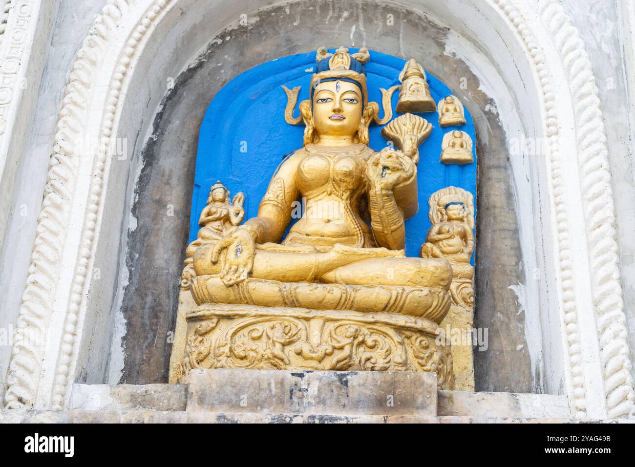Golden statue of buddha sitting in lotus position inside a temple in ...