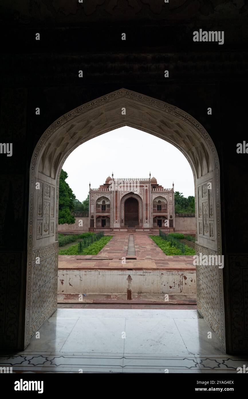 Breathtaking view of a mughal mausoleum through an intricately carved ...