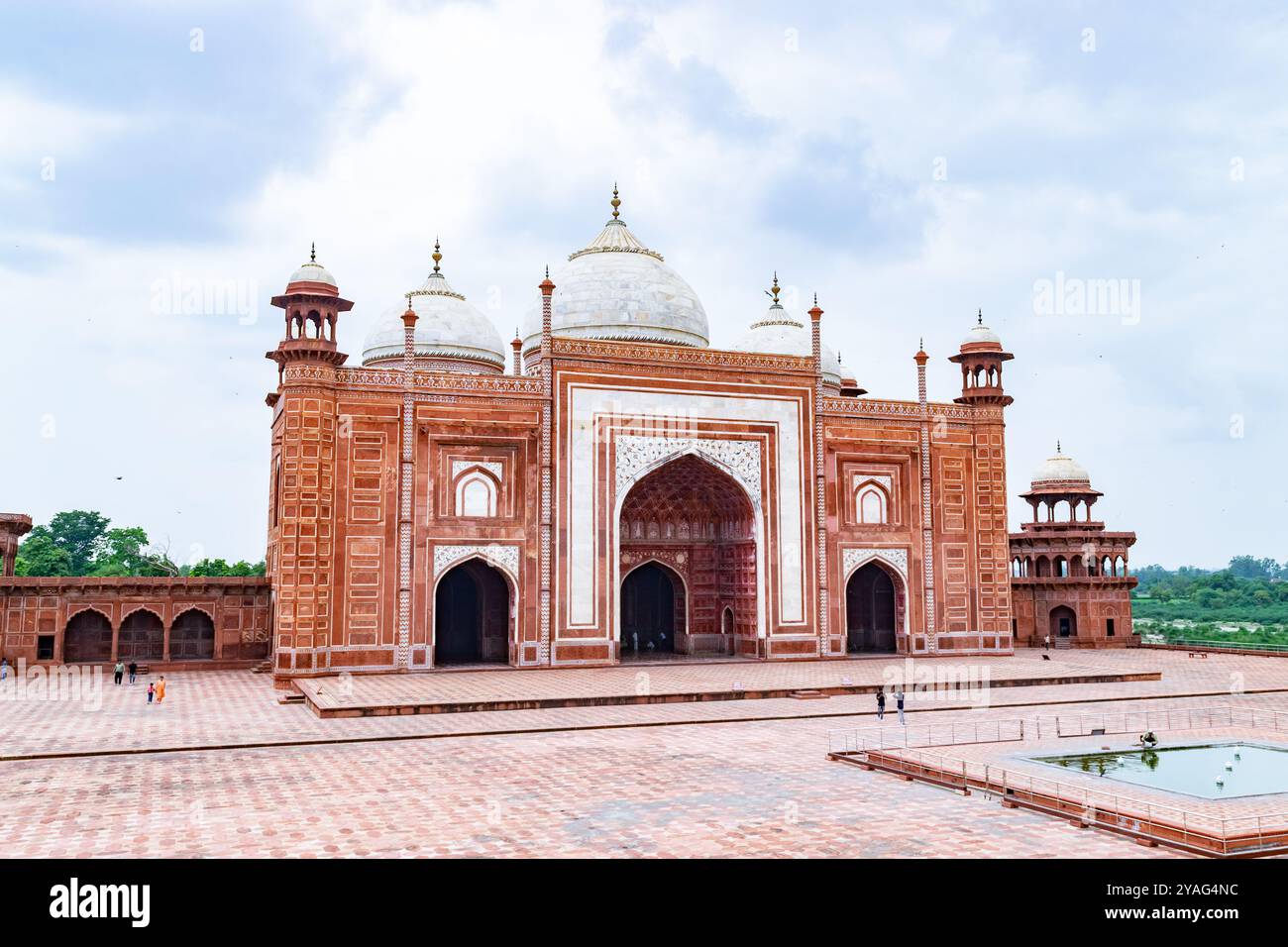 Tourists walking around the taj mahal complex, admiring the ...