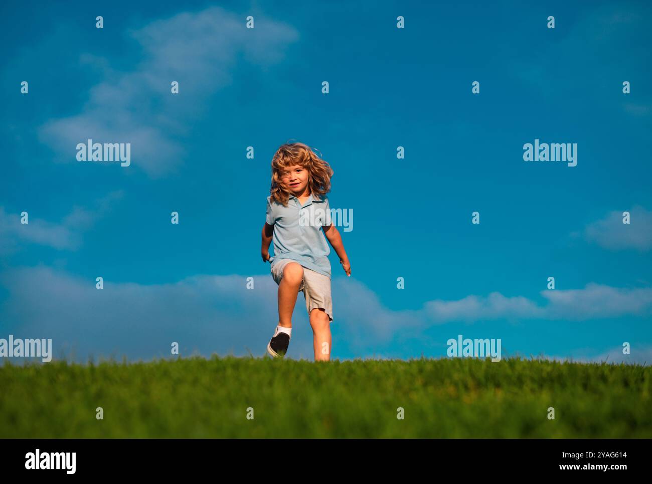 Child boy running on meadow. Happy kid run on beautiful summer field ...