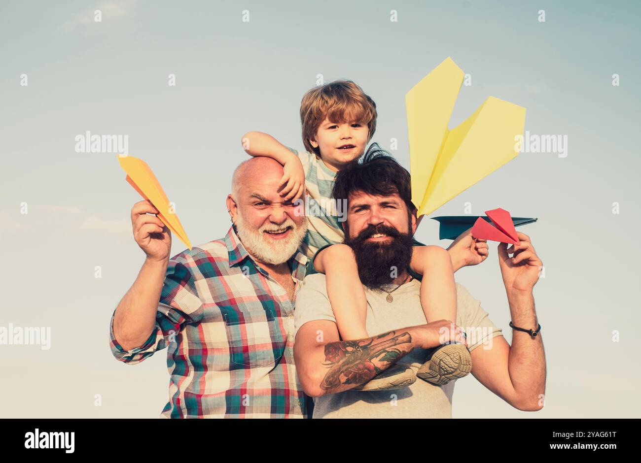 Fathers day - grandfather, father and son are hugging and having fun ...