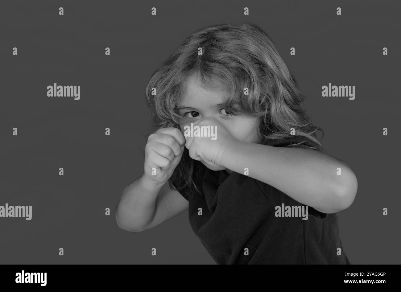 Angry child with fist gesture fight, hit on studio isolated background ...