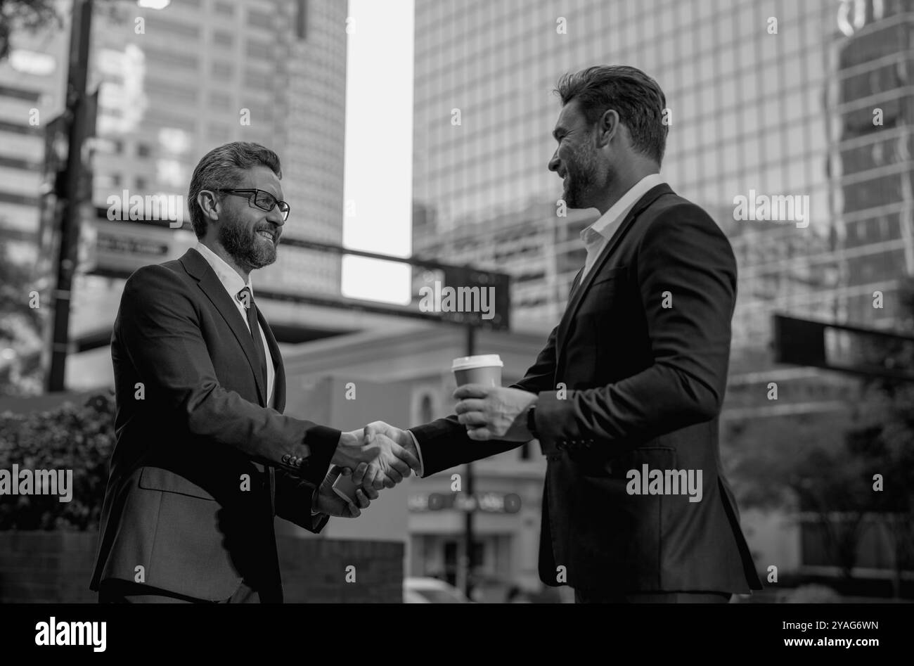 American businessman shaking hands with partner. Businessmen in suit ...